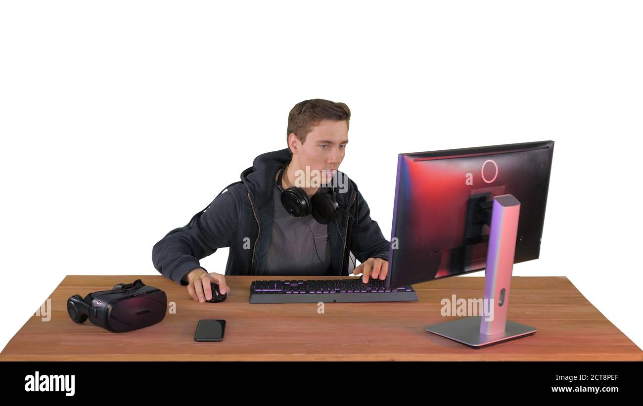 Gamer guy with headphones playing video games on computer and sh Stock ...