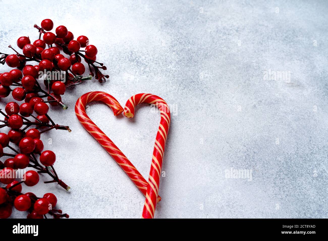 Candy canes on grey frosted background top view Stock Photo - Alamy