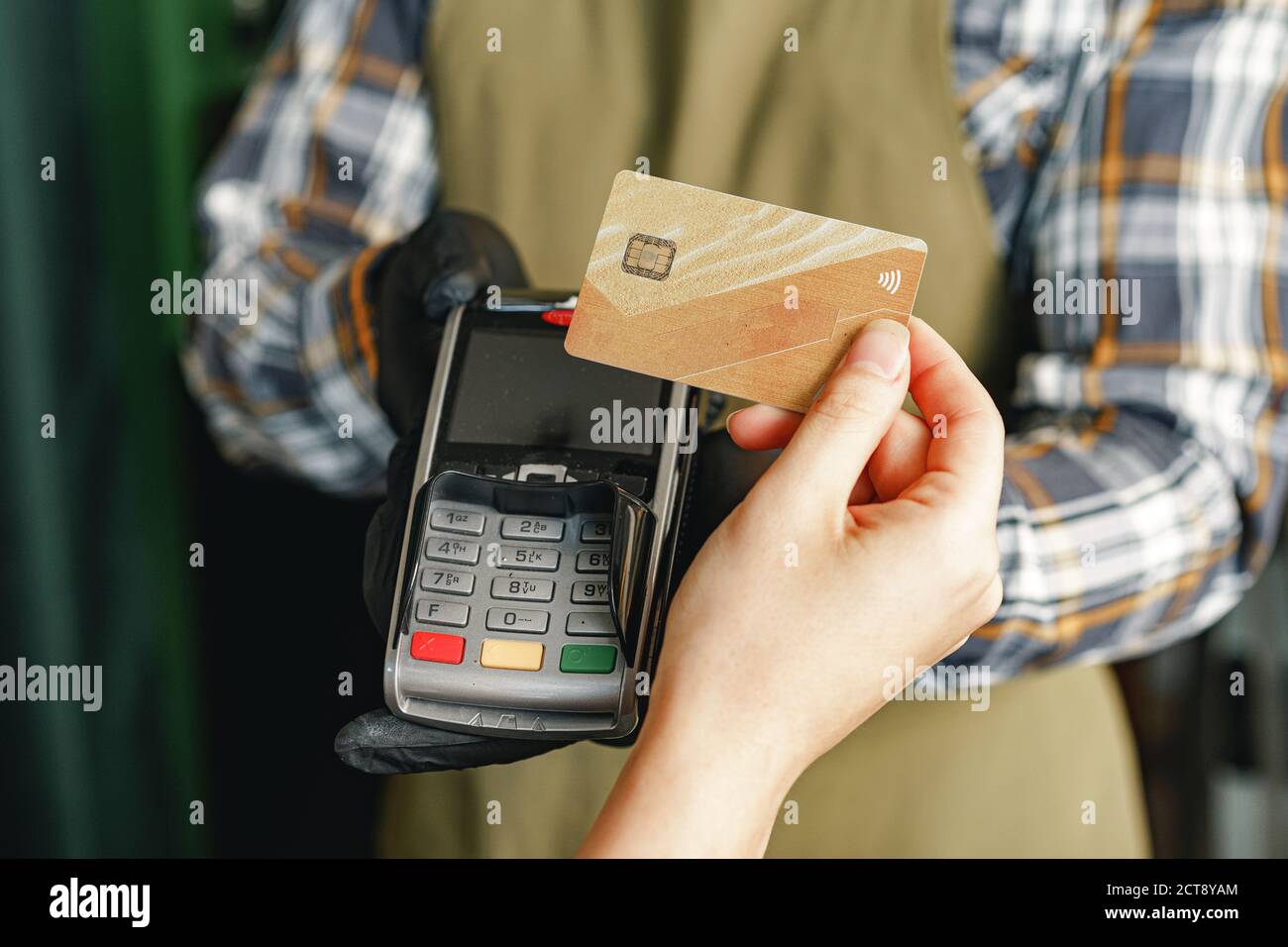 Customer using credit card for payment at cafe or shop by terminal with ... Customer using credit card for payment at cafe or shop by terminal with ...