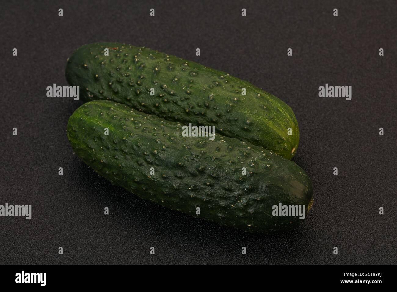 Green fresh two cucumbers over background Stock Photo - Alamy