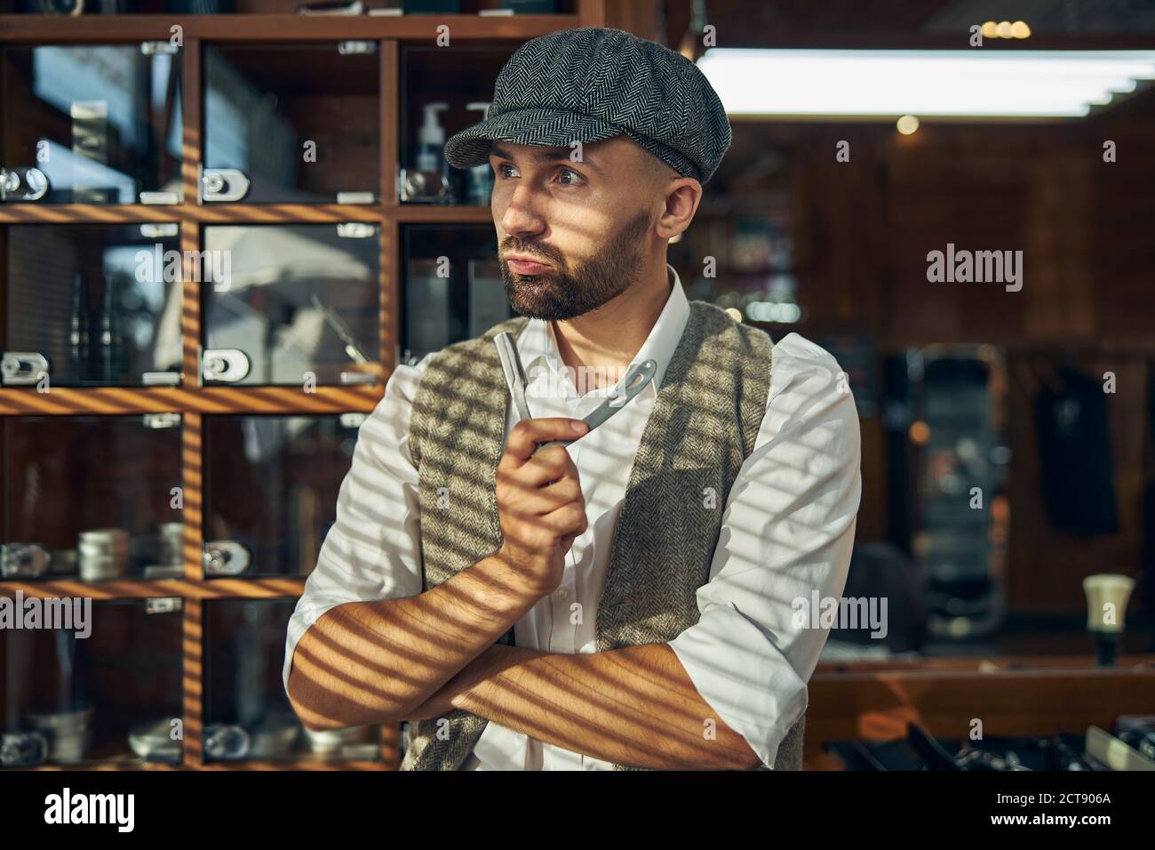 Skillful fancy barber holding a straight razor Stock Photo - Alamy