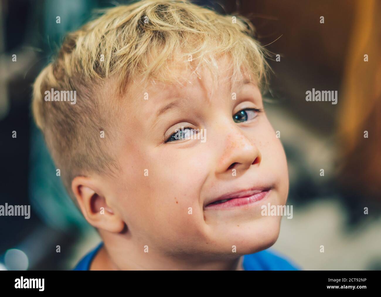 Close up portrait cute smiling blue eyed freckled blond boy pronounced ...