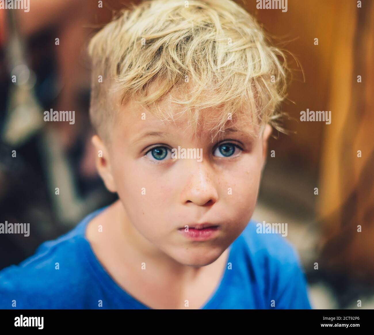 Close up portrait cute smiling blue eyed freckled blond boy pronounced ...