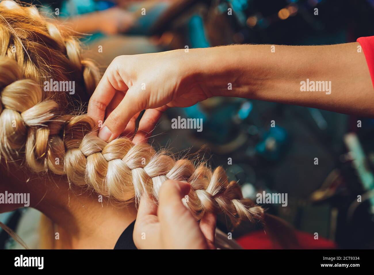 Process of braiding the master weaves braids on her head blond little ...