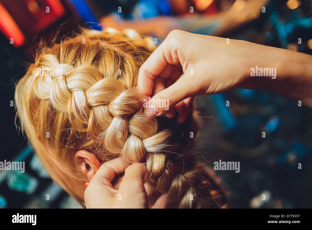 Process of braiding the master weaves braids on her head blond little ...