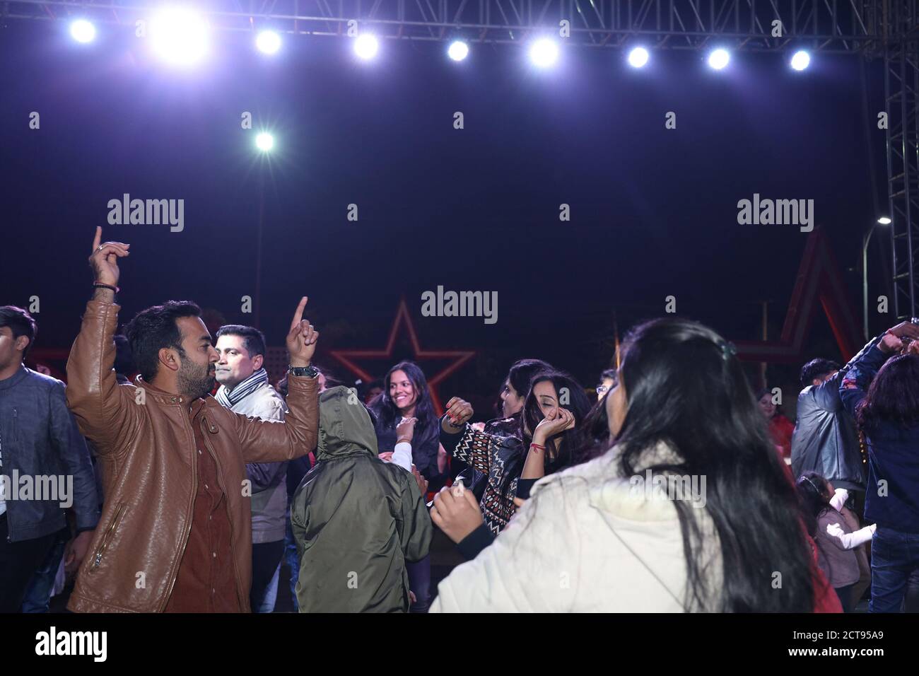 Group of joyful people dancing on a crowded dance floor at a ceremony ...