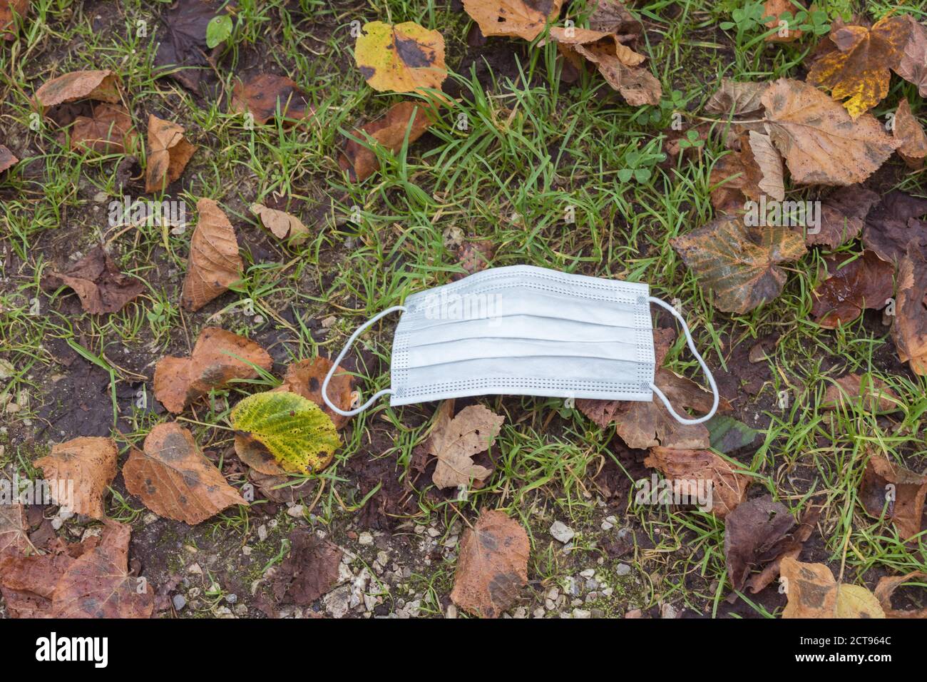 Environmental pollution concept: Single use face mask on the floor ...