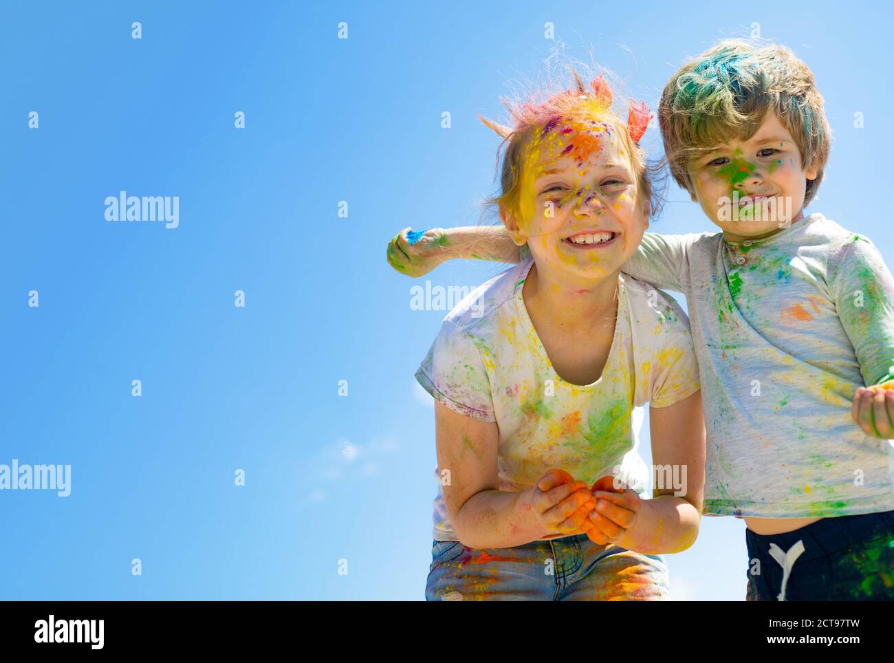 Two kids with face smeared with colors Stock Photo - Alamy