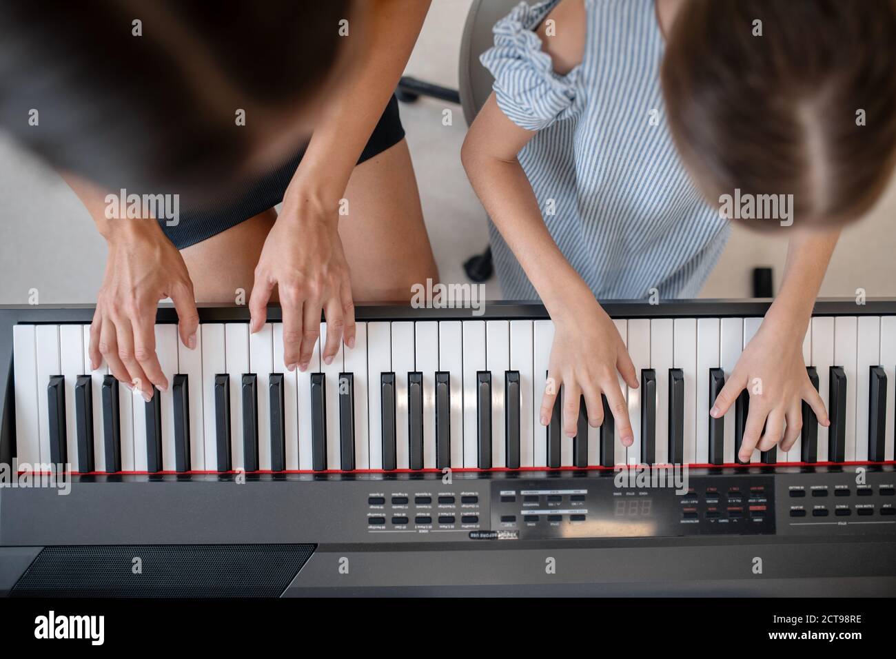 Four hands playing piano hi-res stock photography and images - Alamy