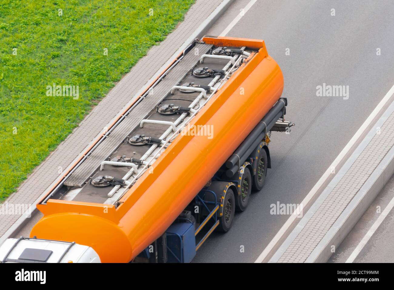 Large orange tank trailer tanker truck rolling on highway Stock Photo ...