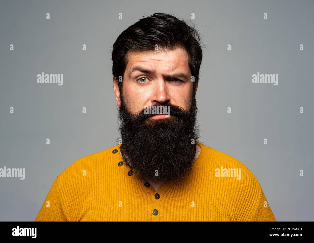 Confident serious man has beard and mustache. Hipster guy models in ...