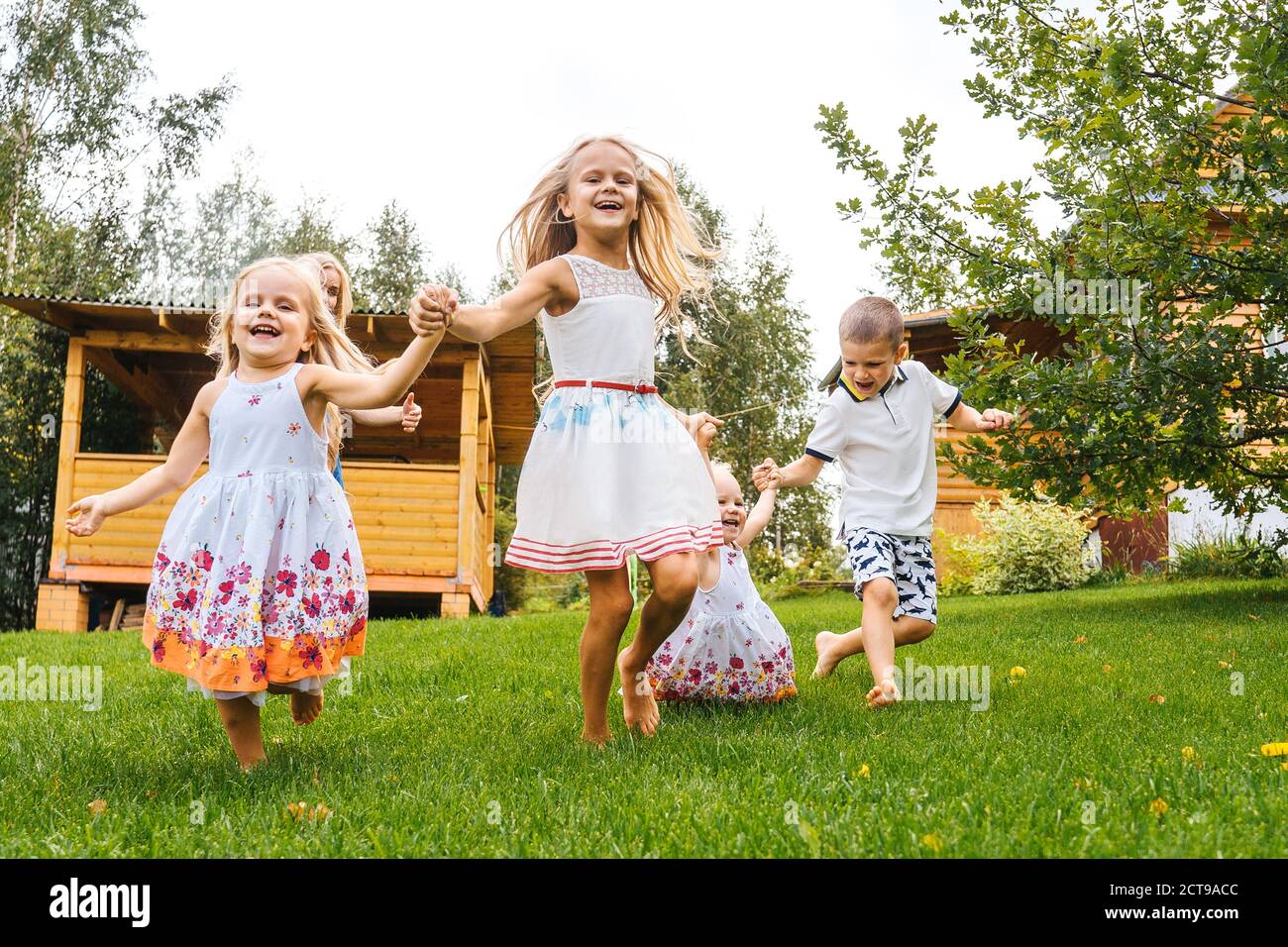 Happy kids running in garden on grass. Summer time Stock Photo - Alamy