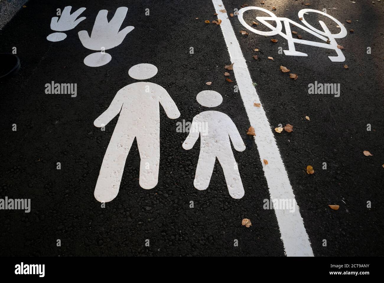 white pedestrian pathway marking on tarmac Stock Photo - Alamy