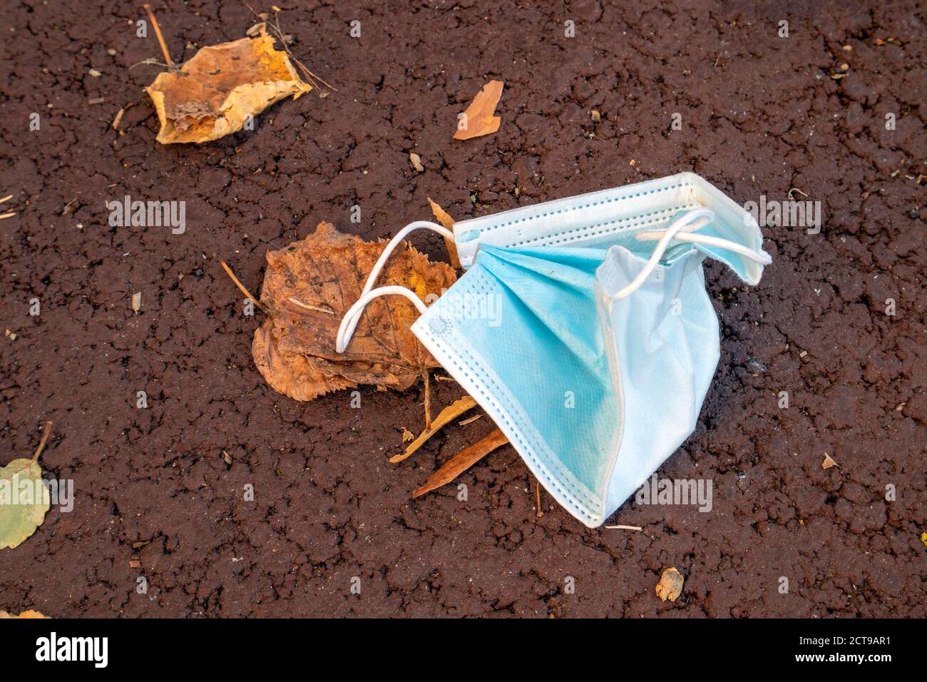 used coronavirus respiratory infection protection mask on ground Stock ...