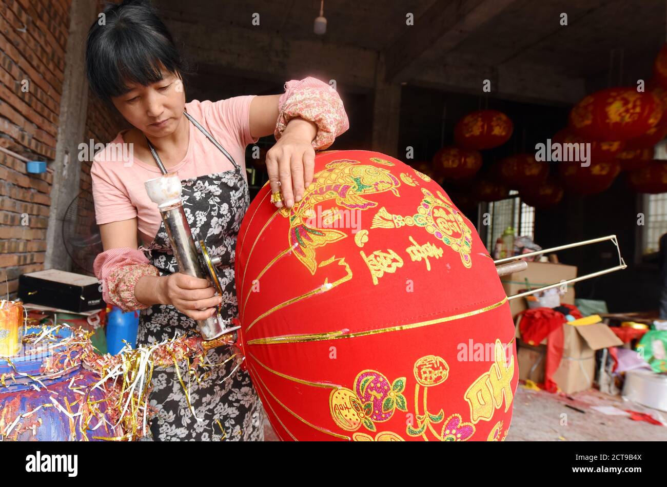 The workers are making red lanterns for the coming national day in ...