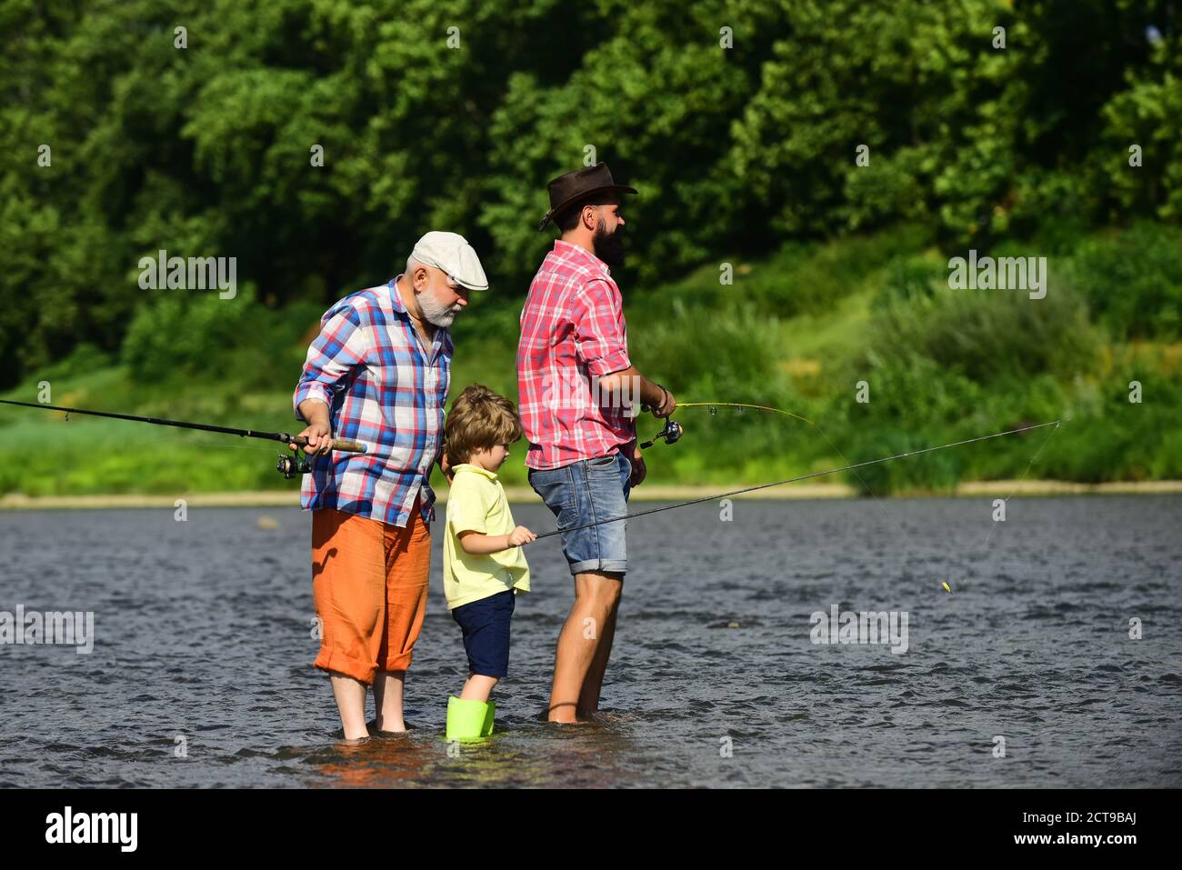 Fly Fishing. Little boy fly fishing on a lake with his father and ...