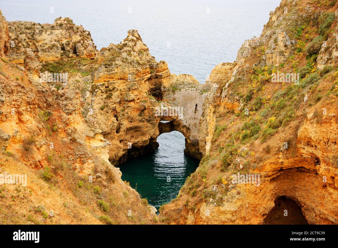 Ocean water seen through hole in rocks. Stone arches, caves, rock ...