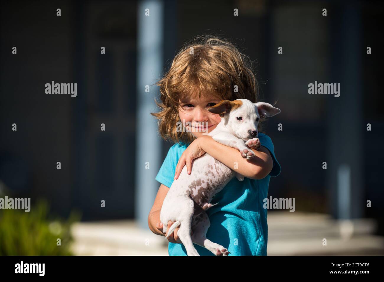 Happy child boy hugging dog, hug friends Stock Photo - Alamy