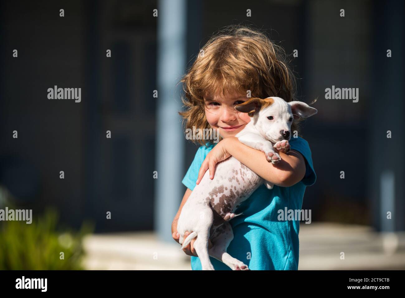 Happy kid boy hugging a dog. Cute child and puppy playing outside Stock ...