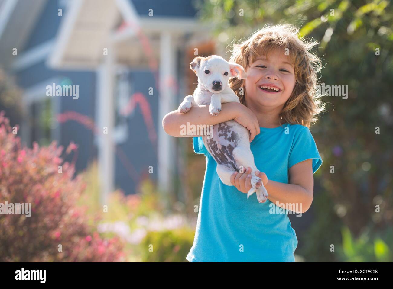 Child walk with a dog outdoor. Cute kid hug puppy Stock Photo - Alamy