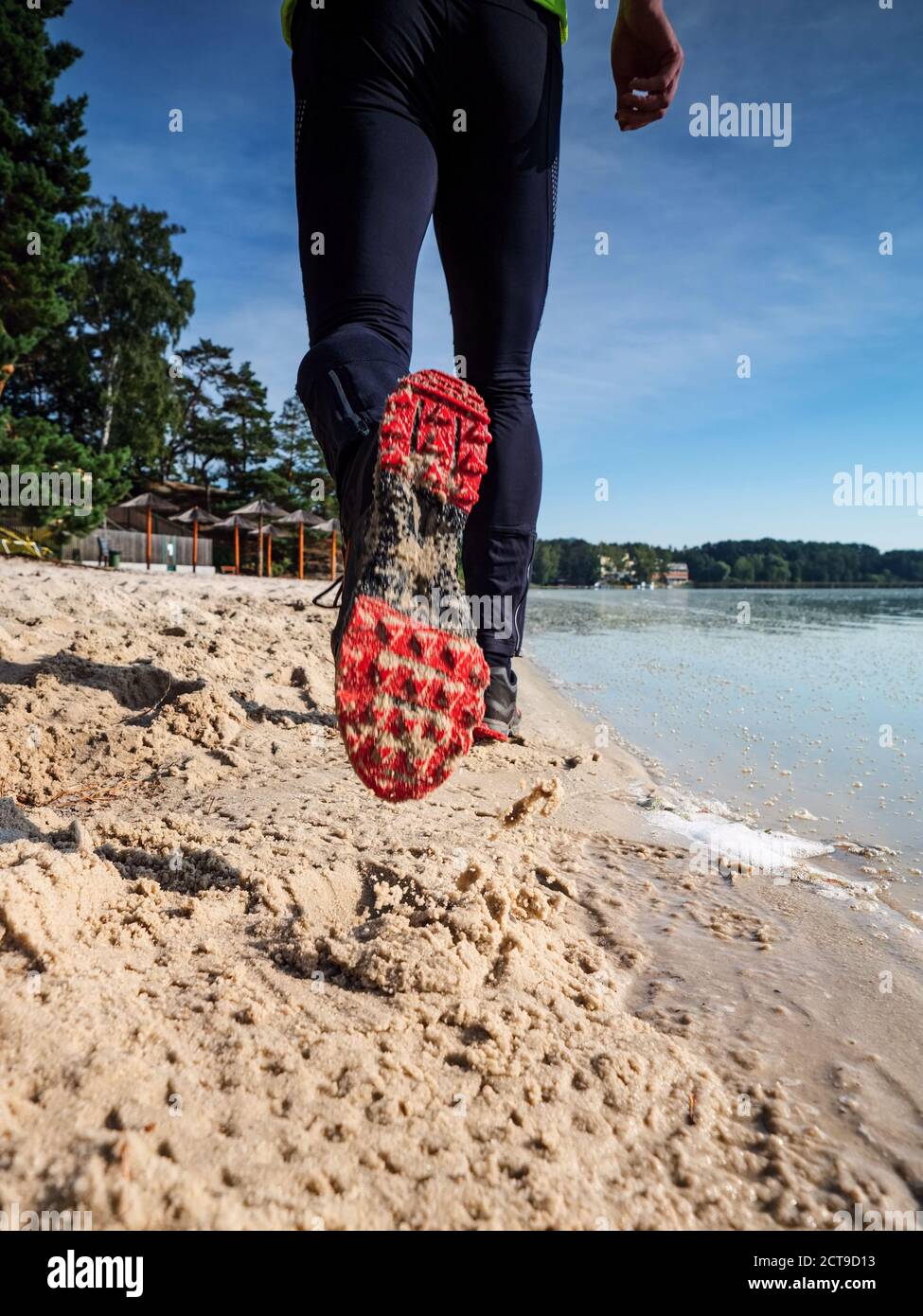 Morning condition workout on beach. Silhouette of running figure along ...