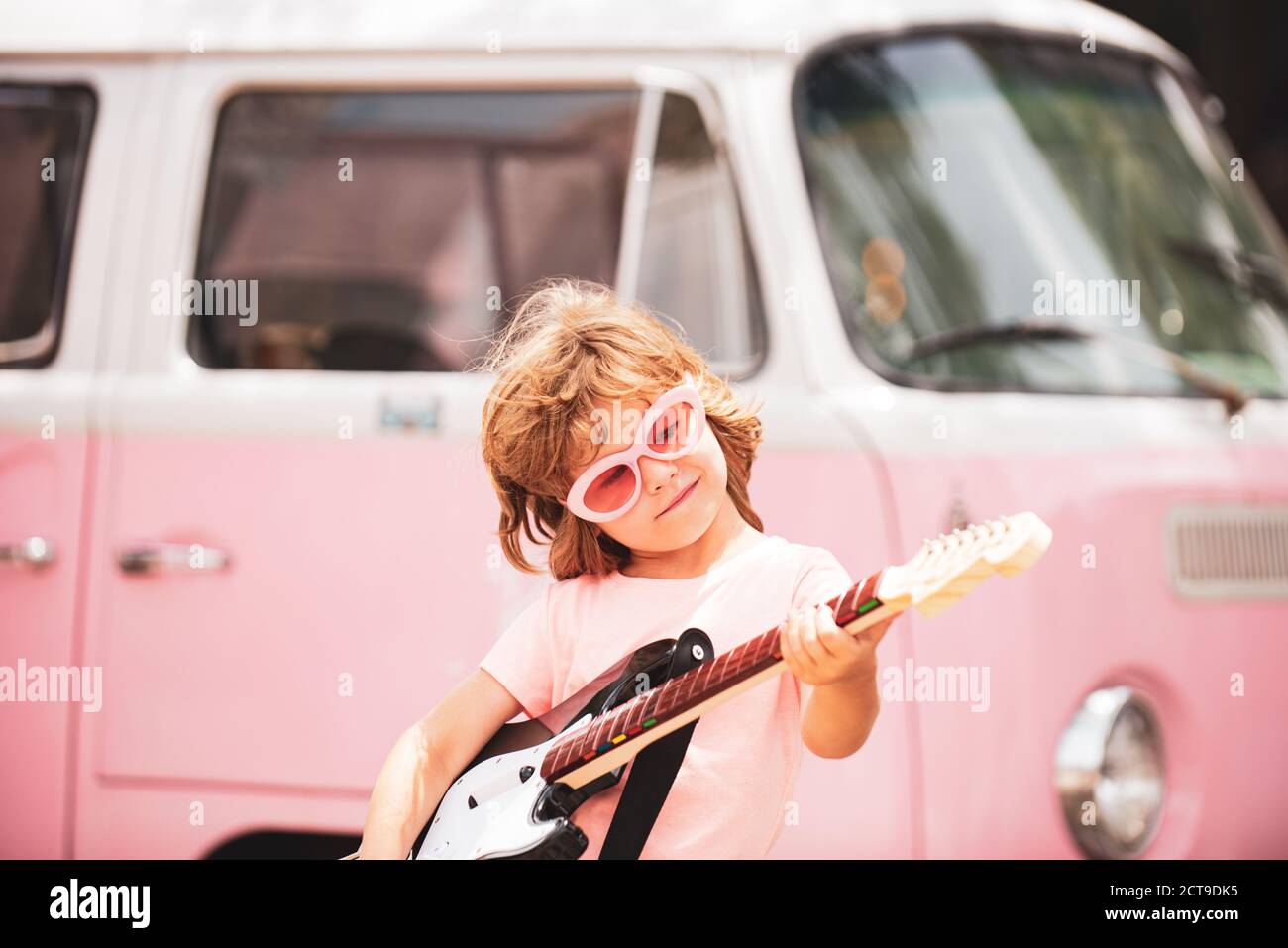 Boy playing guitar outside hi-res stock photography and images - Alamy