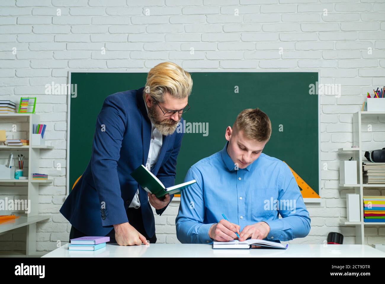 Student and teacher in class Stock Photo - Alamy