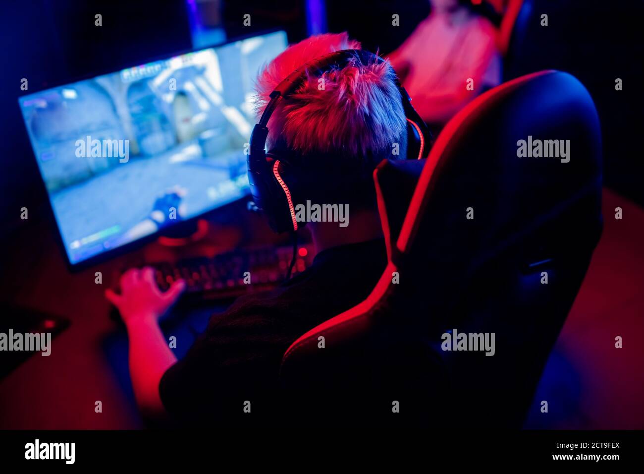 Professional gamer playing online games tournaments pc computer with ...