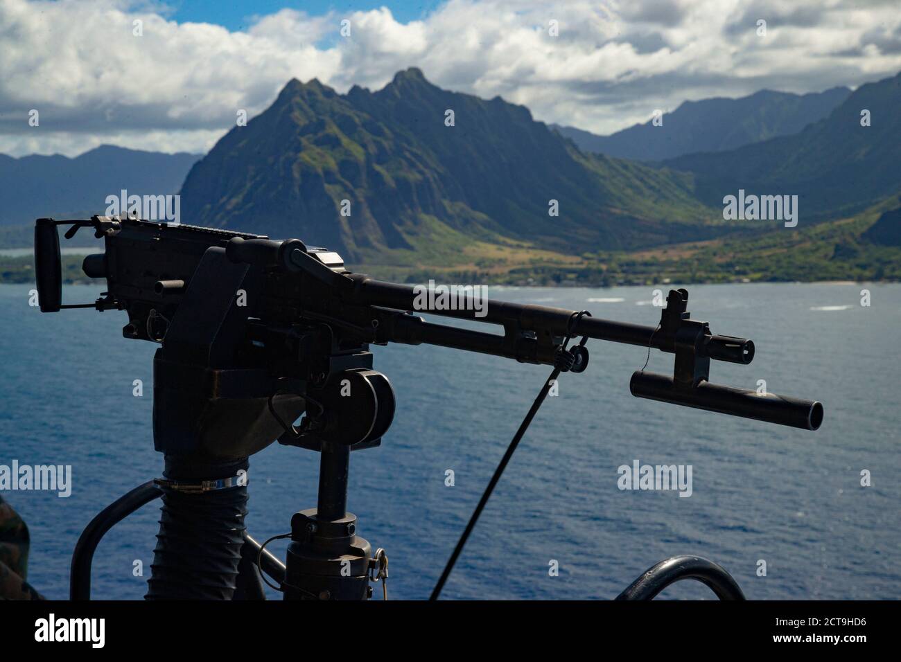 An M240-D machine gun is mounted on the side of a UH-1Y Venom with ...