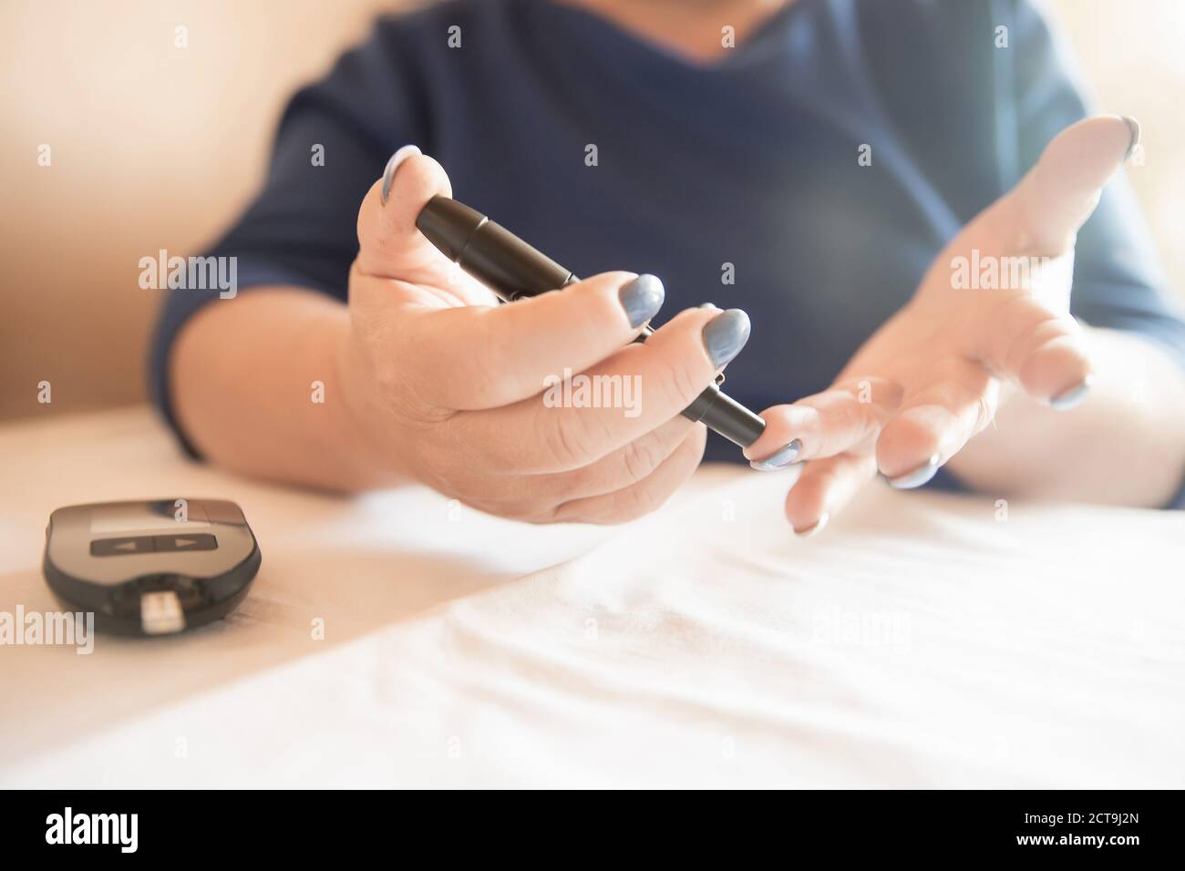 Woman use glucometer for checks blood sugar level for diabetes, insulin ...