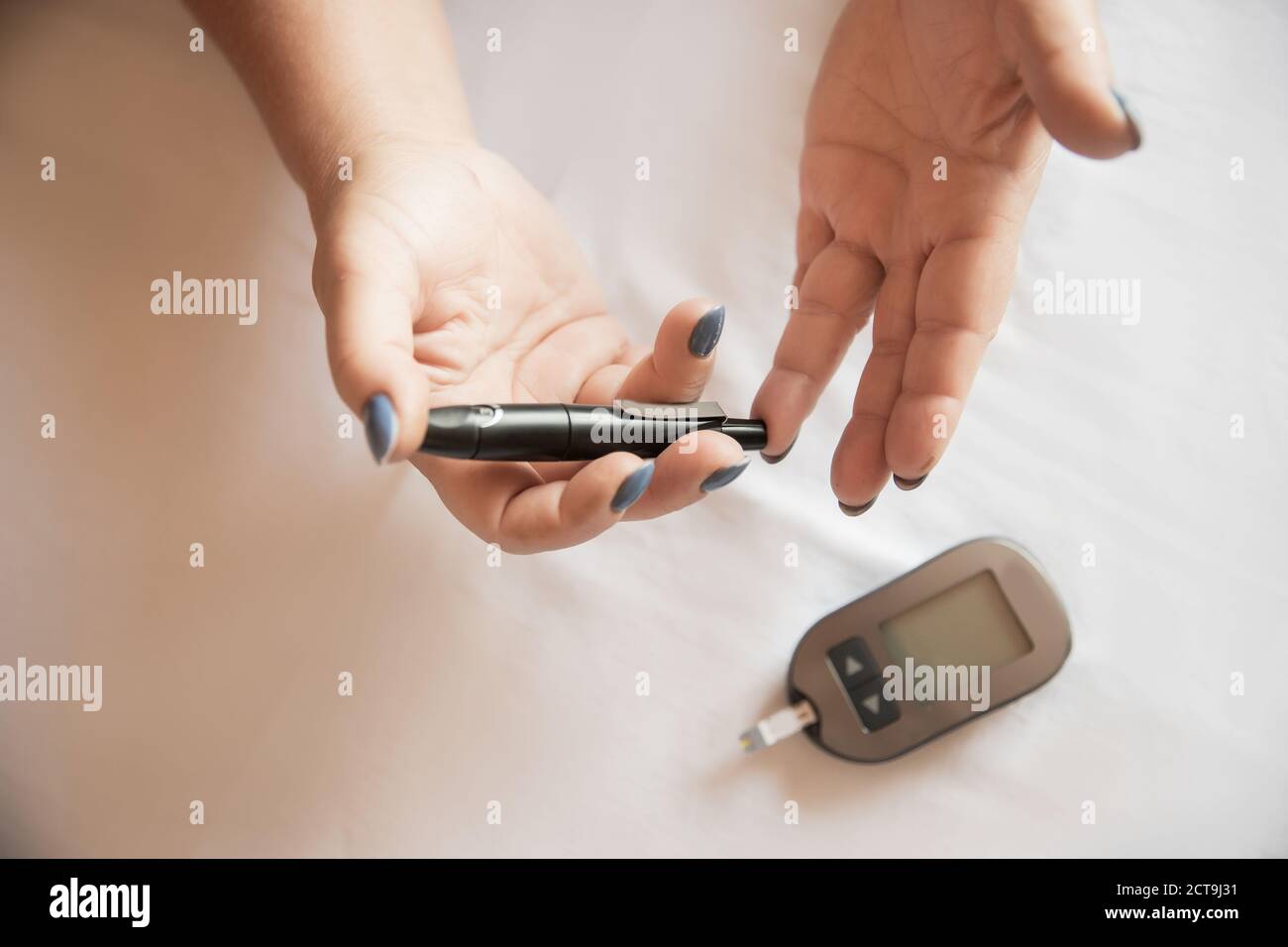 Woman use glucometer for test sugar blood level for diabetes, insulin ...