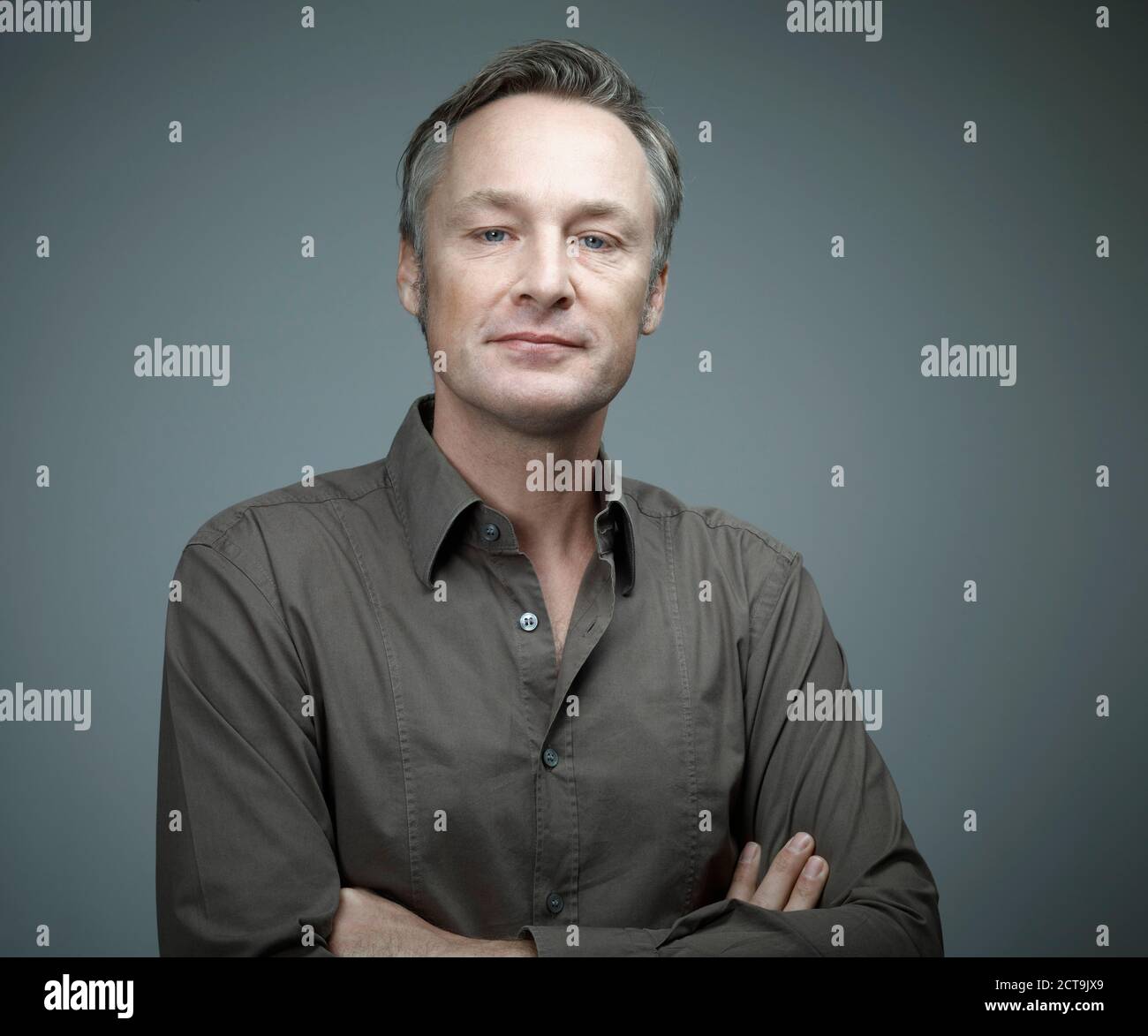 Portrait of man with crossed arms Stock Photo - Alamy
