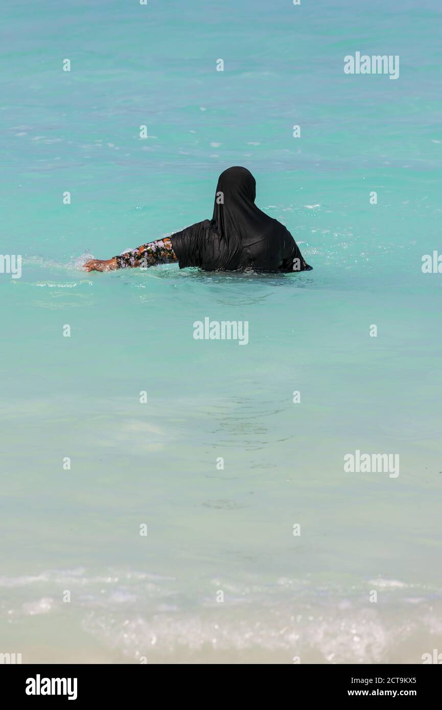 Maldives, Muslim woman in the ocean with traditional clothing Stock ...