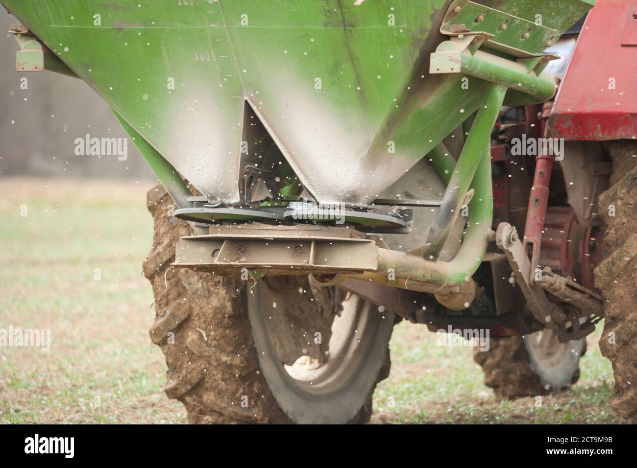Sowing artificial fertilizer with tractor hi-res stock photography and ...