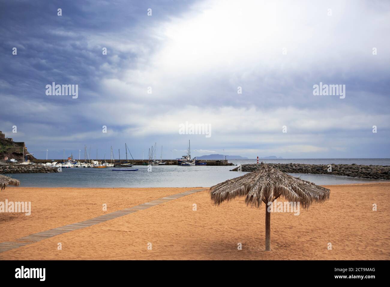 Portugal, Madeira, Machico, Yellow beach with beach umbrella, view to ...