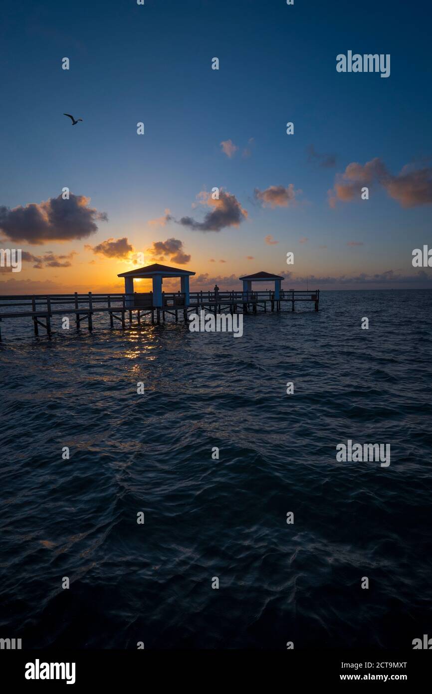 USA, Texas, Rockport, Aransas Bay, Sunrise and wooden fishing pier at ...