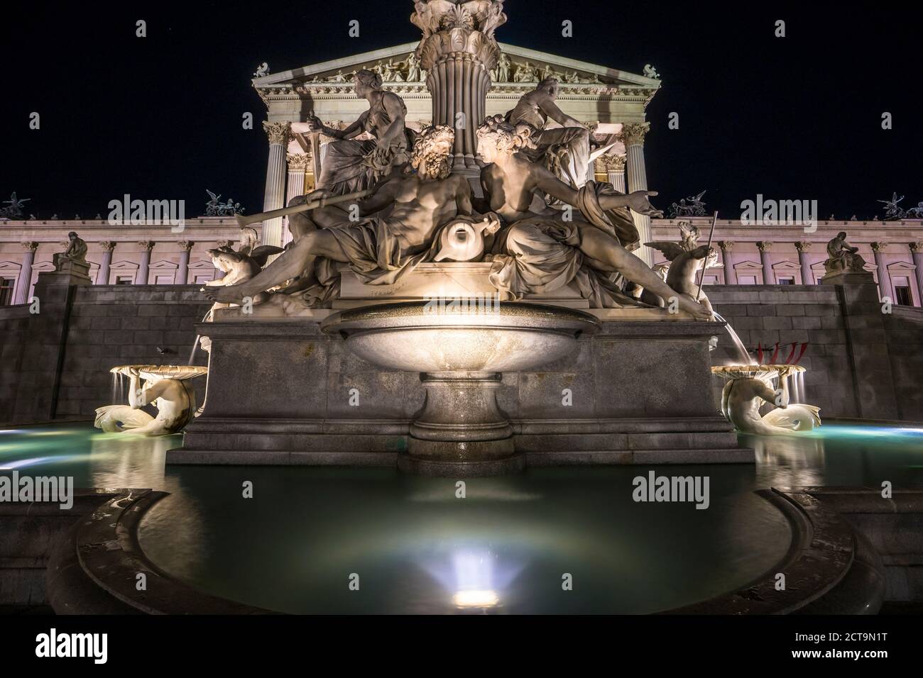 Austria, Vienna, Fountain in front of Parliament Building at night ...