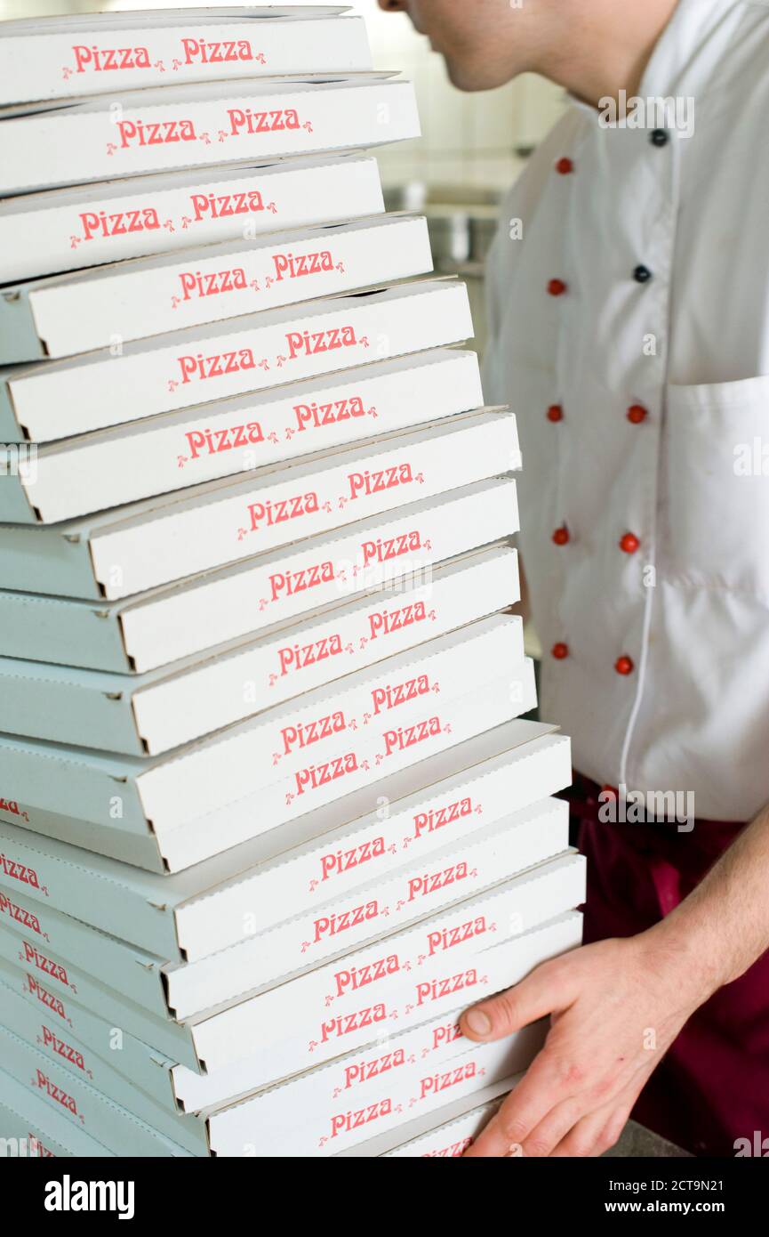 Man carrying stack of pizza boxes Stock Photo - Alamy