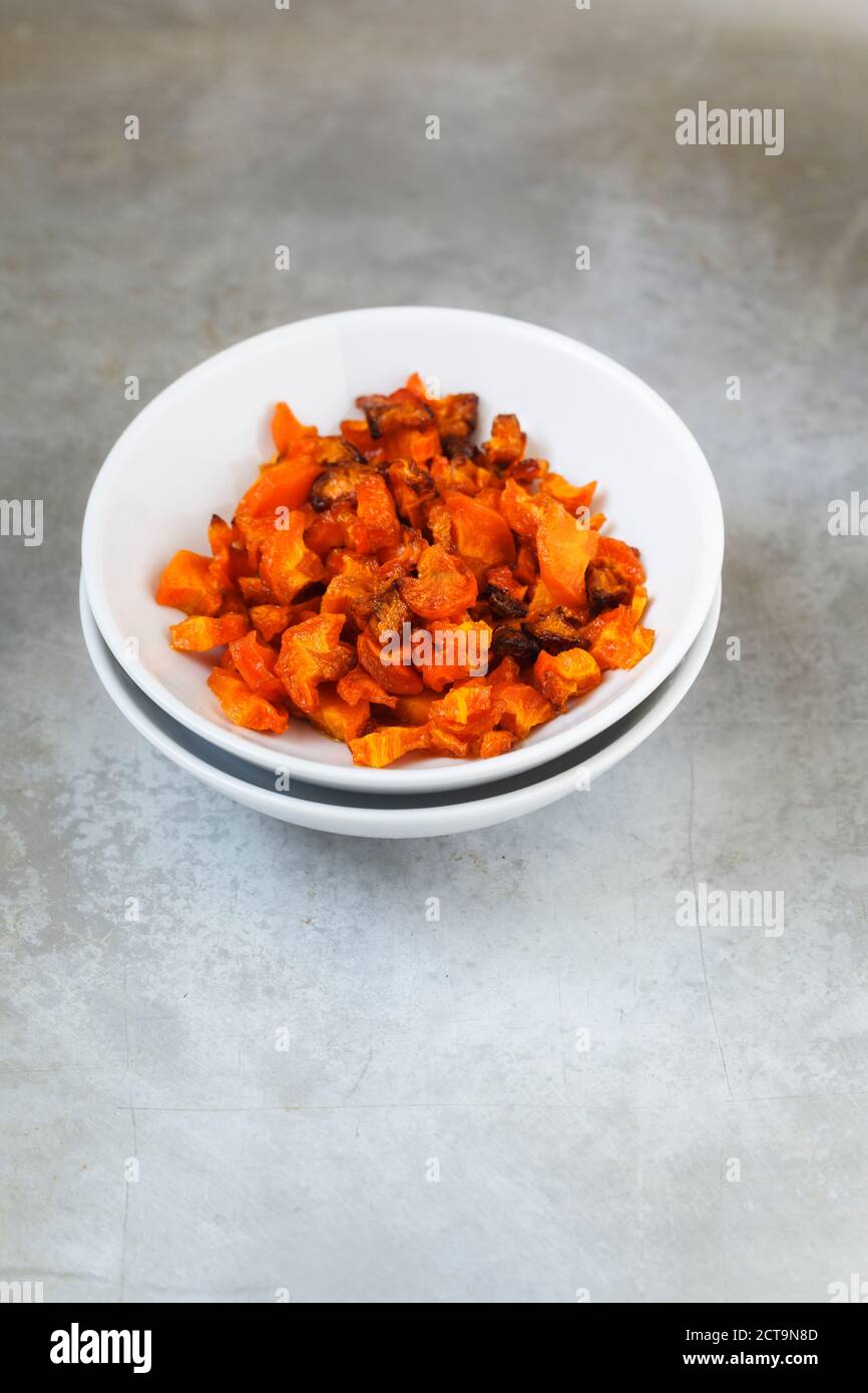 Bowl of roasted chunks of carrots on metal Stock Photo - Alamy
