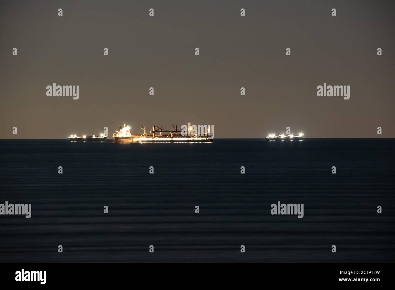 Cargo ship at night in the sea Stock Photo - Alamy