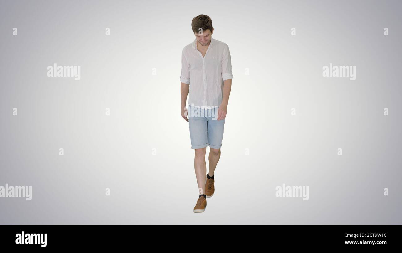 Casual young man walking and looking forward on gradient backgro Stock ...
