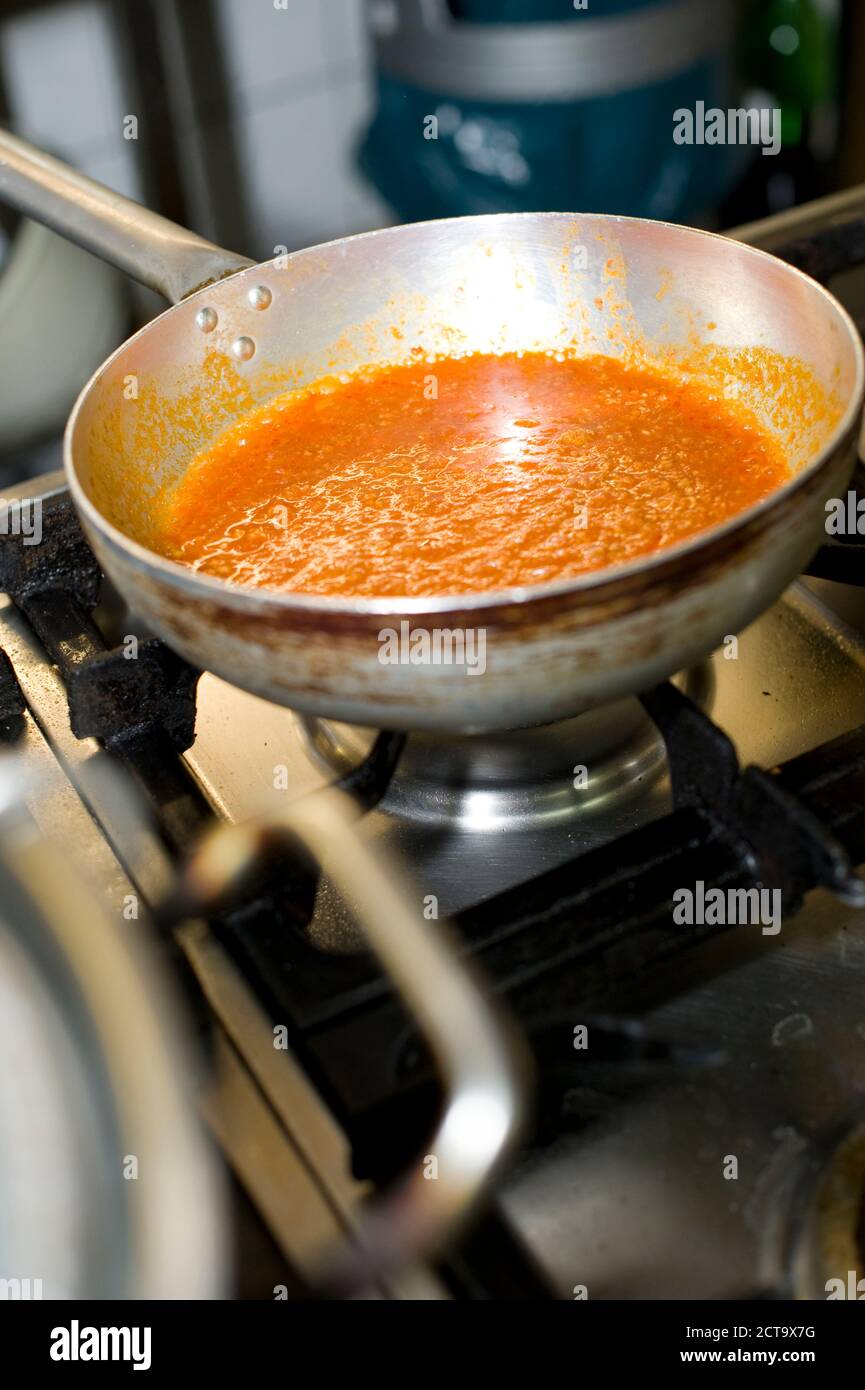 Tomato sauce in a pot at kitchen of Italian restaurant Stock Photo - Alamy