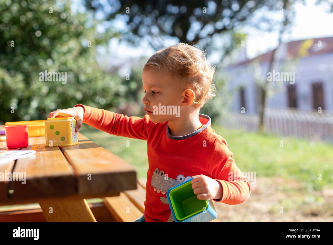 A Baby Boy Playing Educational Cube Toys at Garden Stock Photo - Alamy