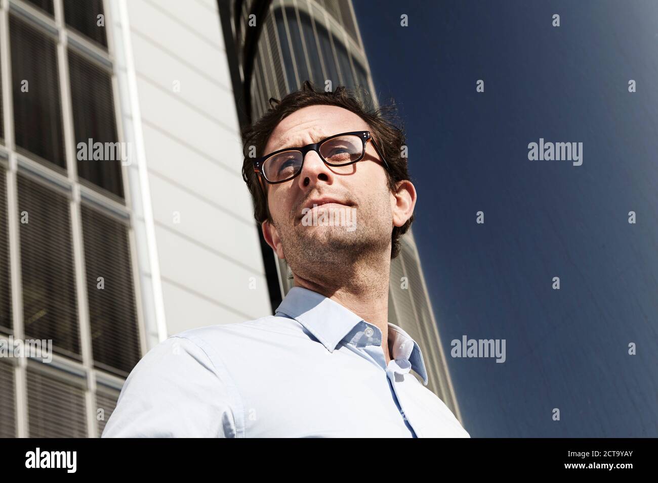 Portrait of man looking at distance Stock Photo - Alamy