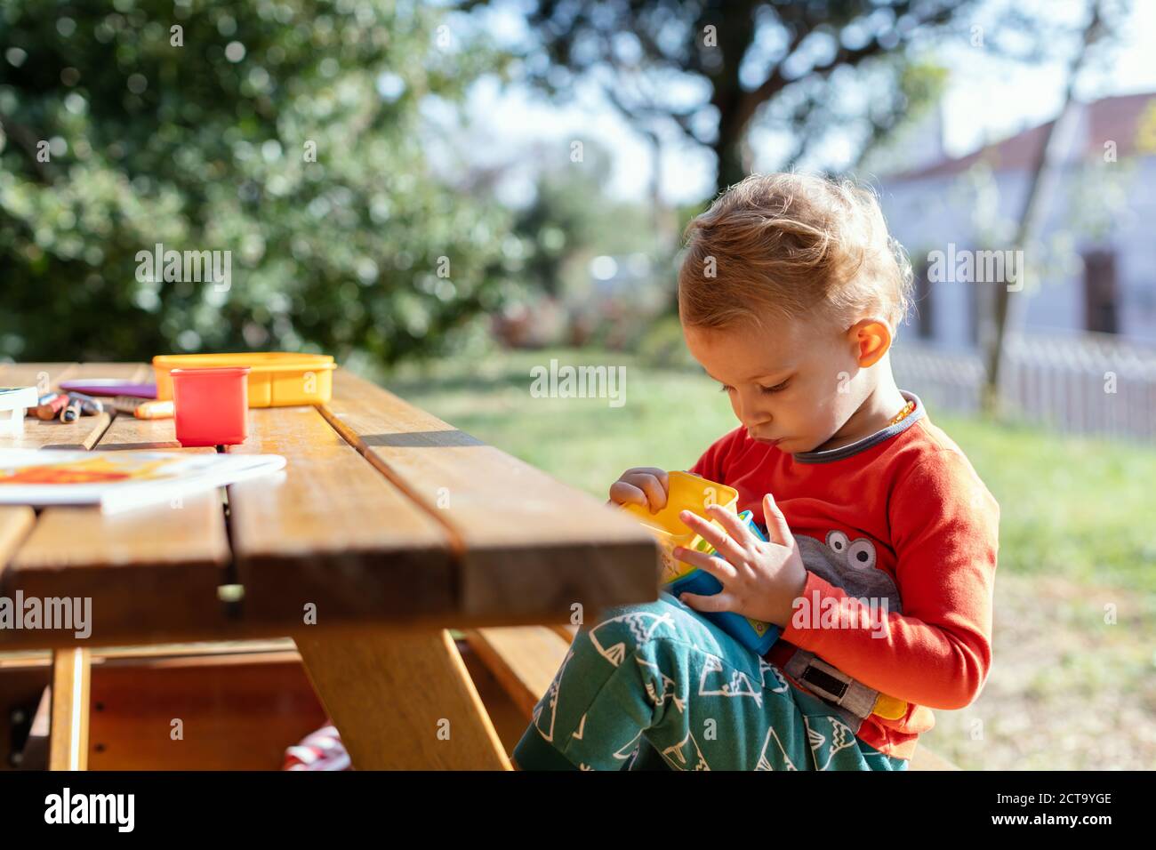 A Baby Boy Playing Educational Cube Toys at Garden Stock Photo - Alamy