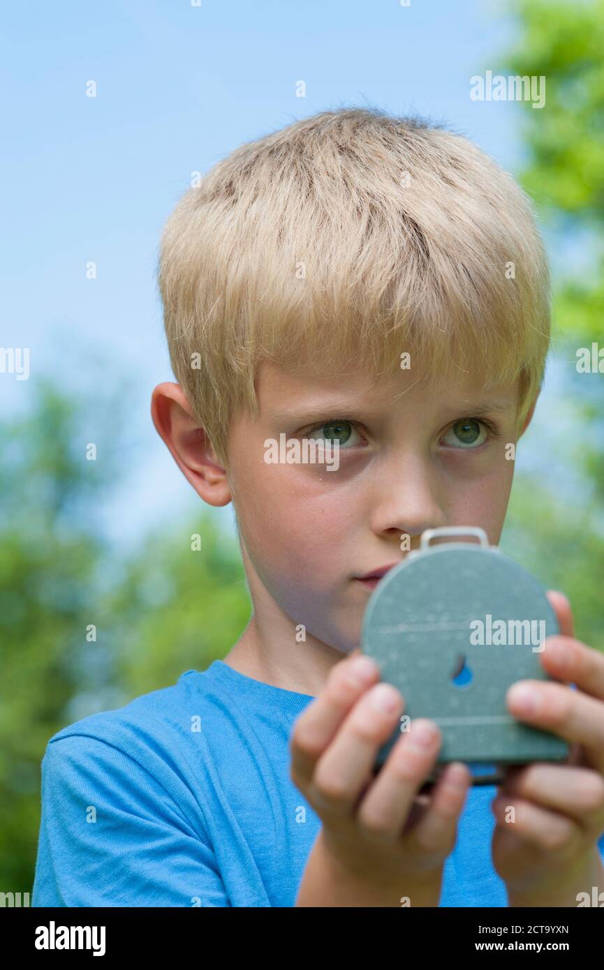 Boy using a compass hi-res stock photography and images - Alamy