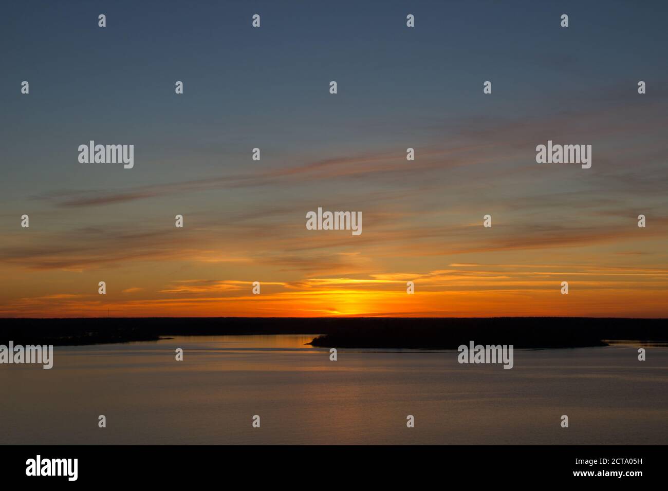 Mesmerizing sunset with colorful clouds reflecting on a sea Stock Photo ...