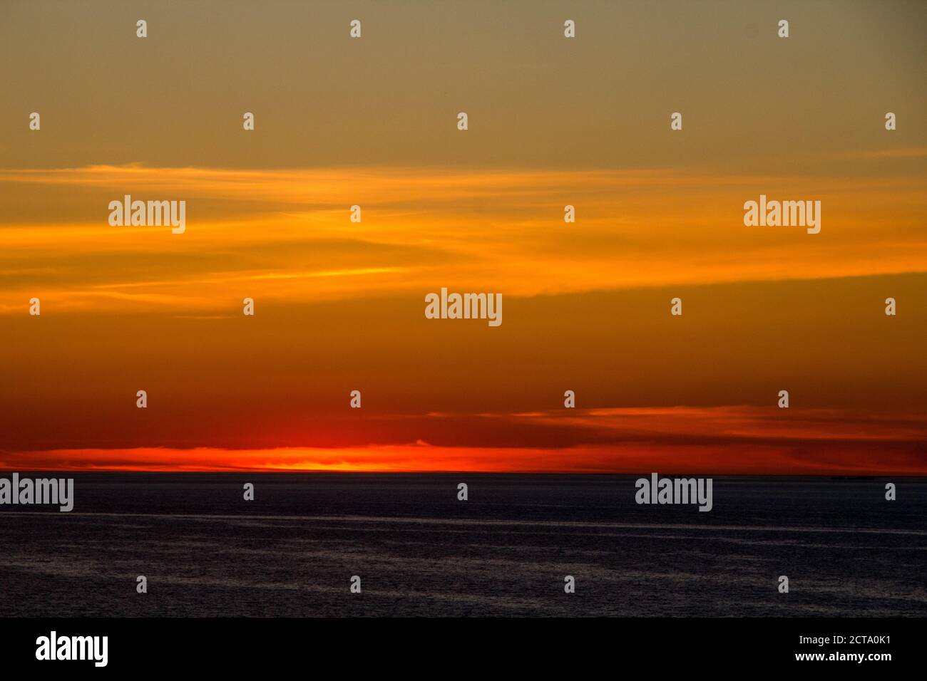 Mesmerizing sunset with colorful clouds reflecting on a sea Stock Photo ...
