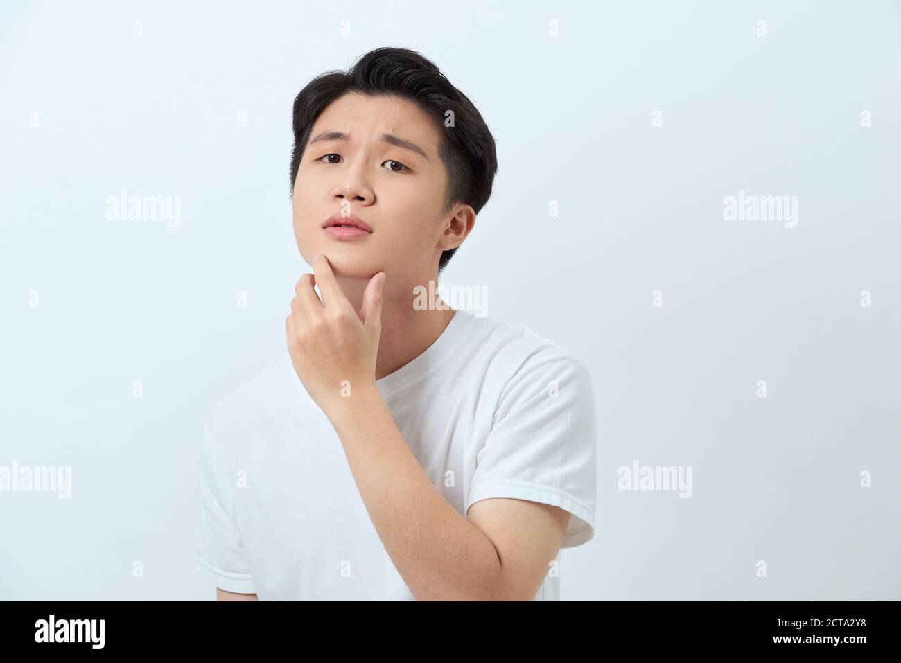 Young handsome man over white background looking confident at the ...