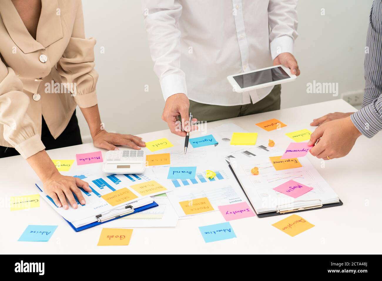 business people planning startup project placing sticky notes session ...